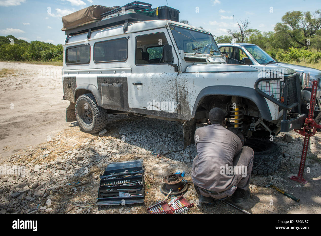 Auto mechanic working on broken down Land Rover in Botswana, Africa ...