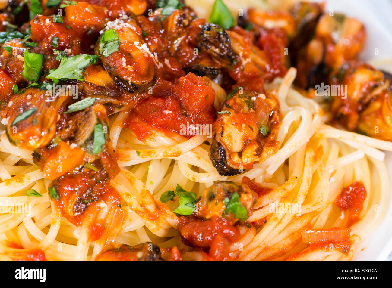 Spaghetti with Mussels in a homemade tomato sauce Stock Photo - Alamy