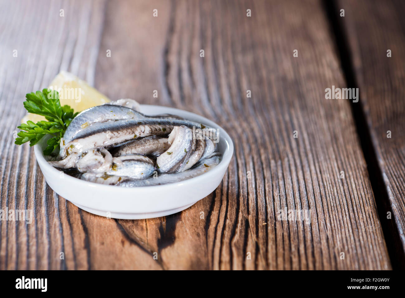 Portion of Anchovis with herbs (close-up shot Stock Photo - Alamy
