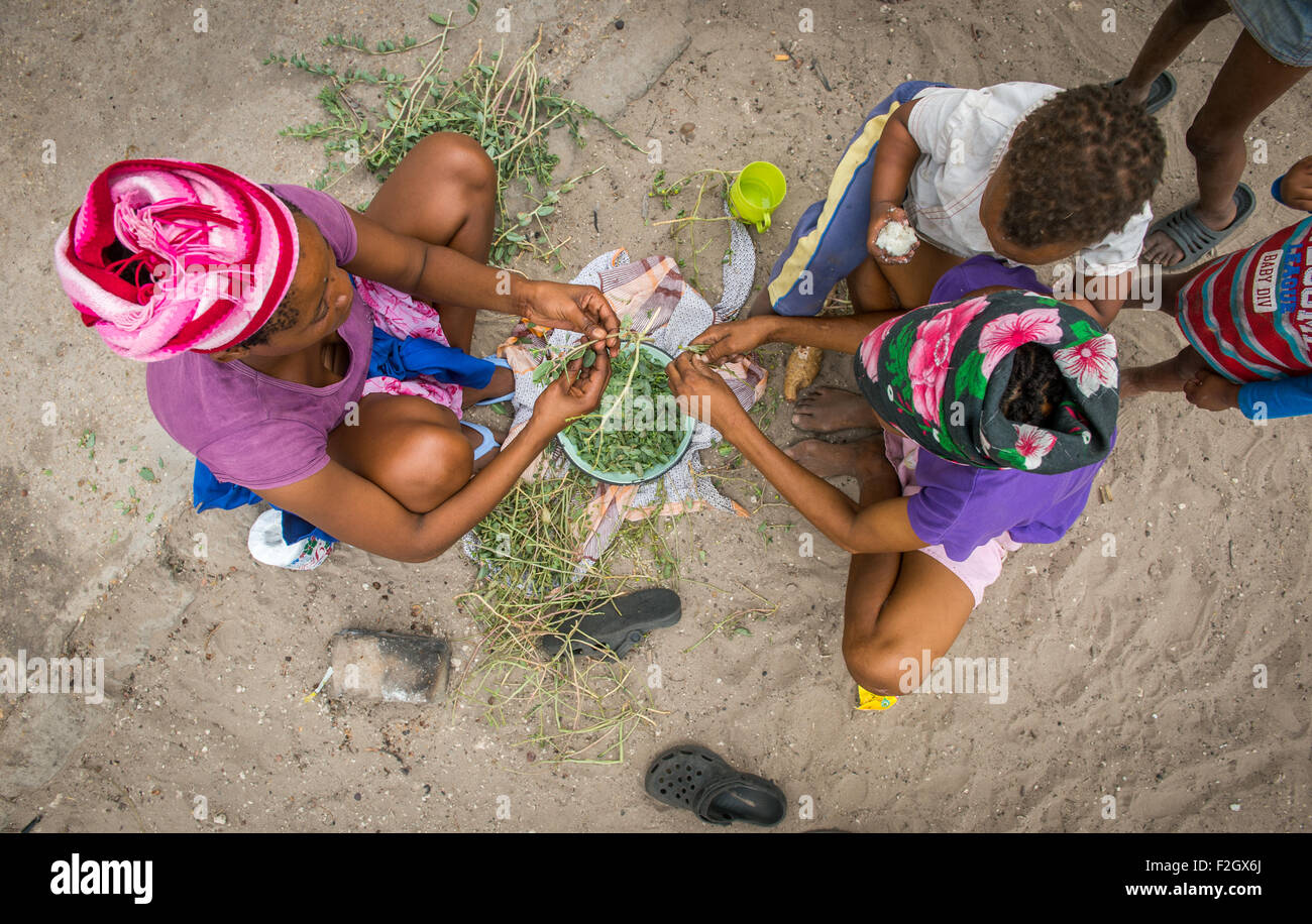 Bushmen or San people preparing food in Botswana, Africa Stock Photo ...