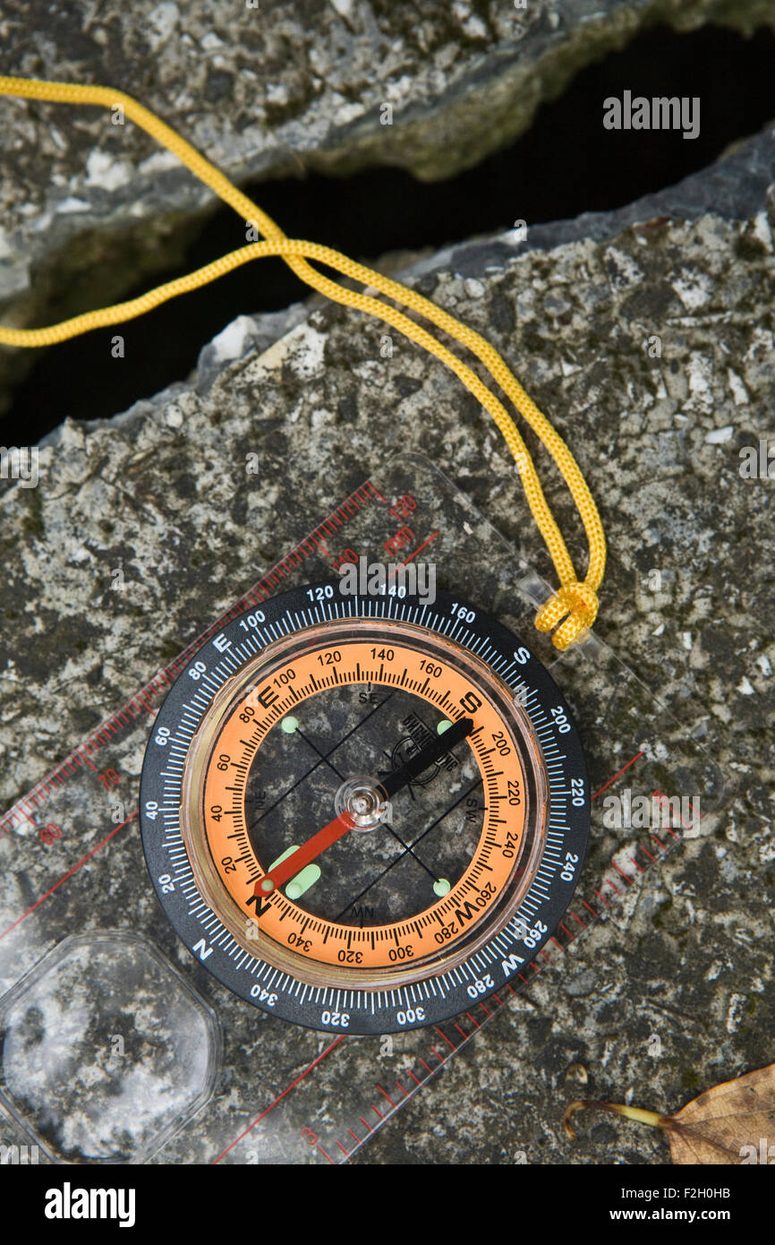 Compass on rock in closeup Stock Photo - Alamy