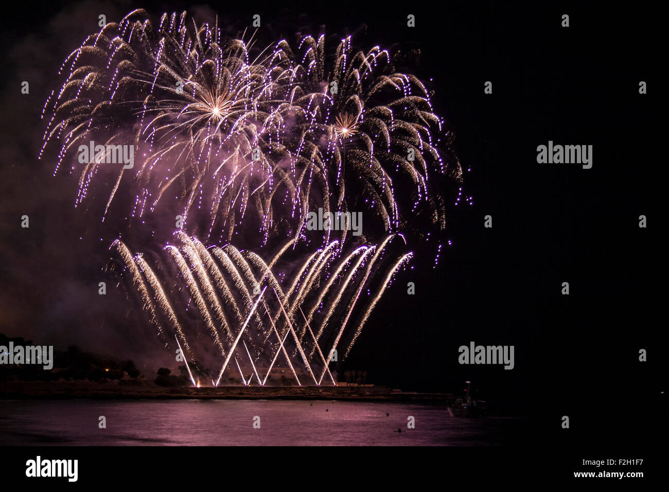 Fireworks over sea and Reflecting in Water Stock Photo - Alamy
