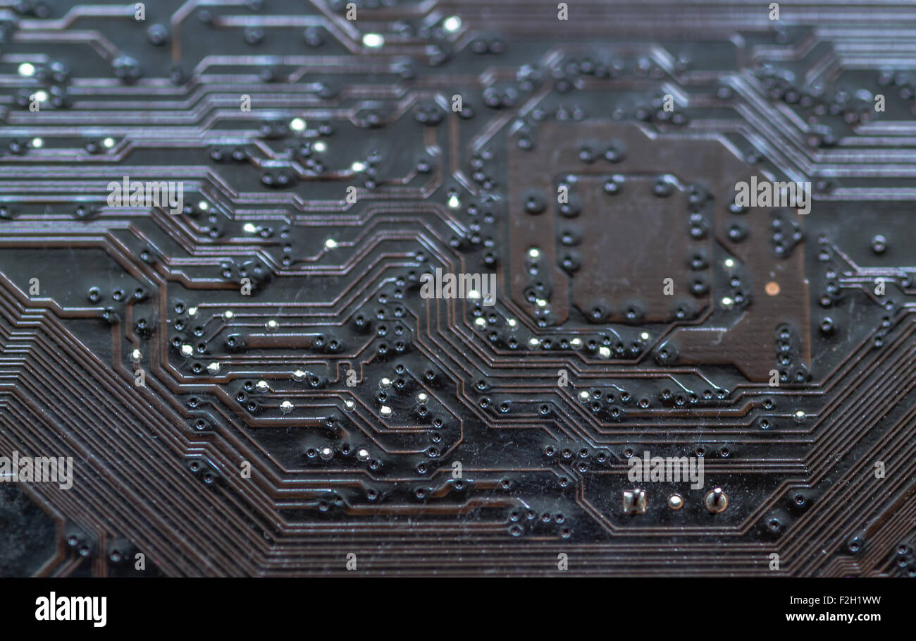 Macro closeup of a computer PCB Motherboard using brown and black ...