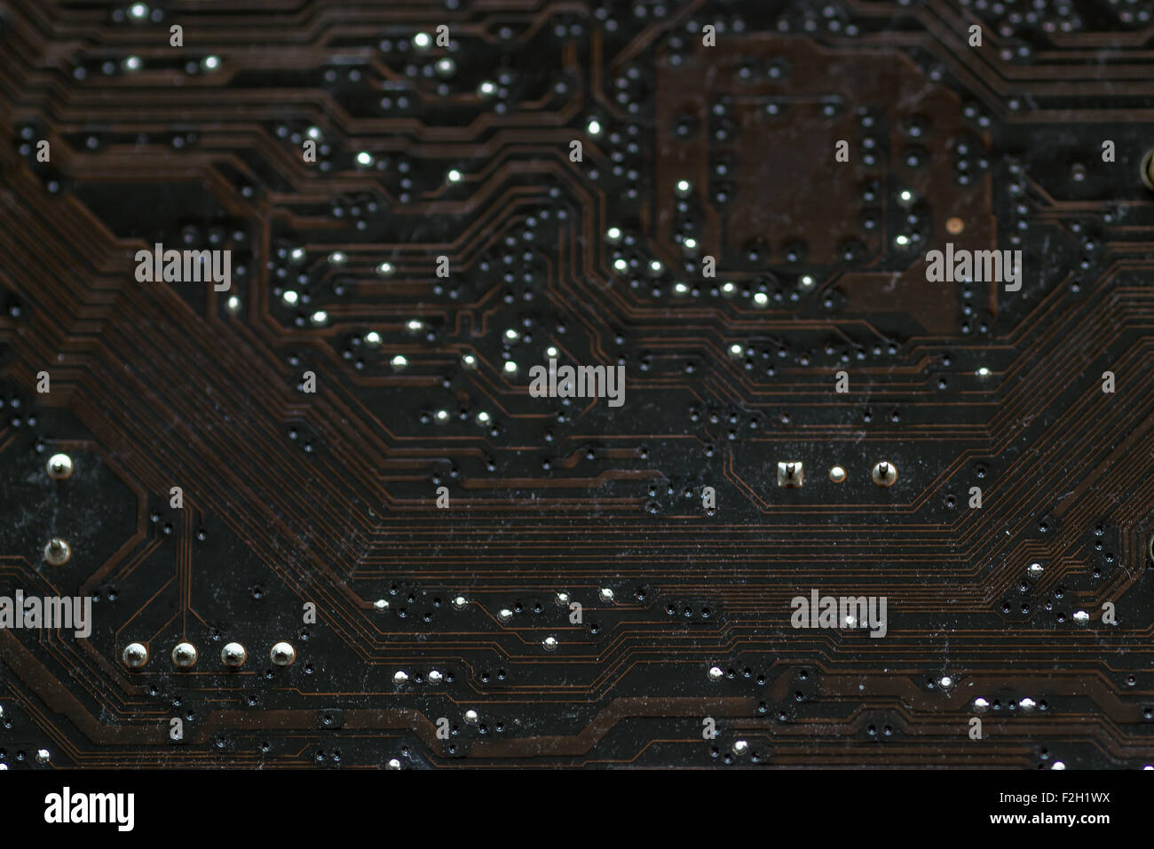 Macro closeup of a computer PCB Motherboard using brown and black ...