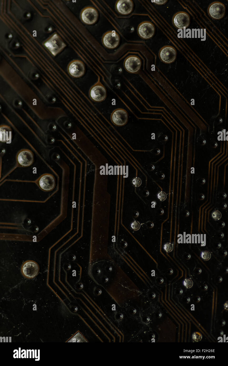 Macro closeup of a computer PCB Motherboard using brown and black ...