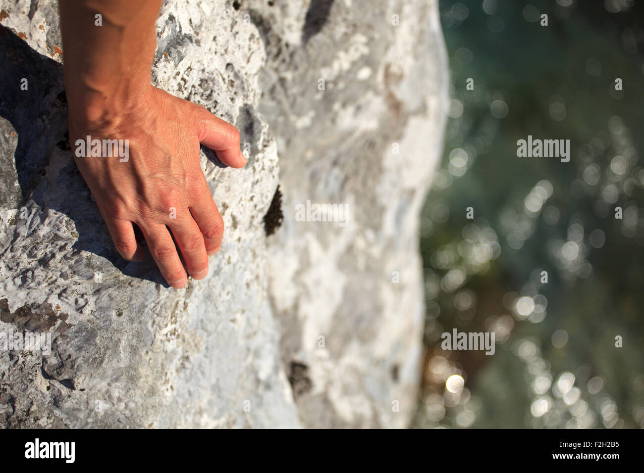 Photo of Female hand on white rock Stock Photo - Alamy