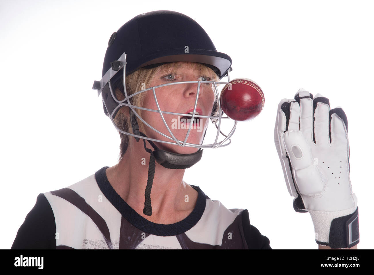 Cricketer wearing safety helmet being hit by a cricket ball Stock Photo ...