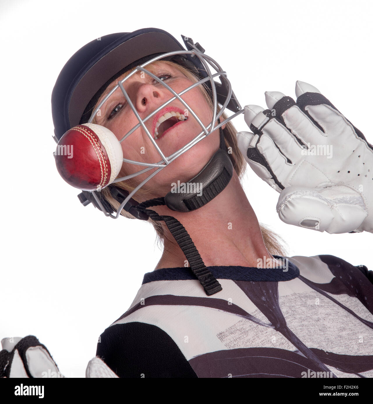 Cricketer wearing safety helmet being hit by a cricket ball Stock Photo ...
