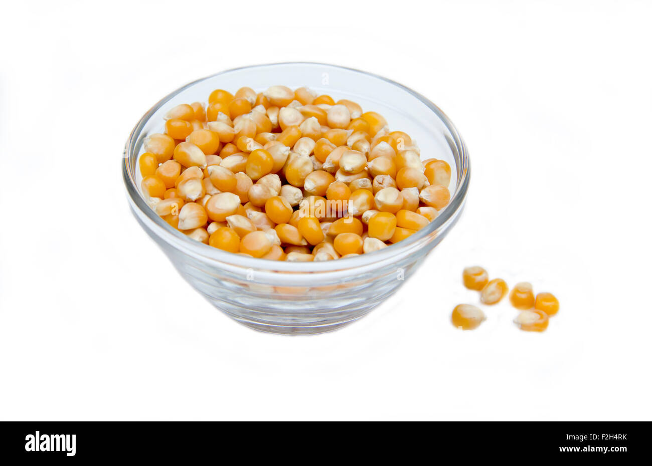 Maize grains dried on bowl on white background Stock Photo - Alamy