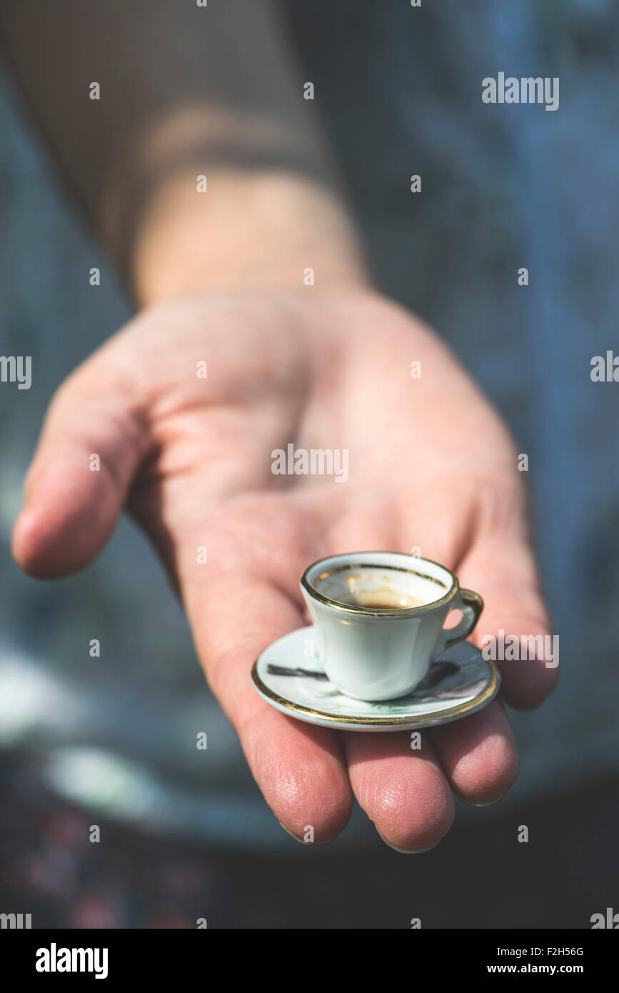 Hand hold very small cup of coffee. Miniature cup Stock Photo - Alamy