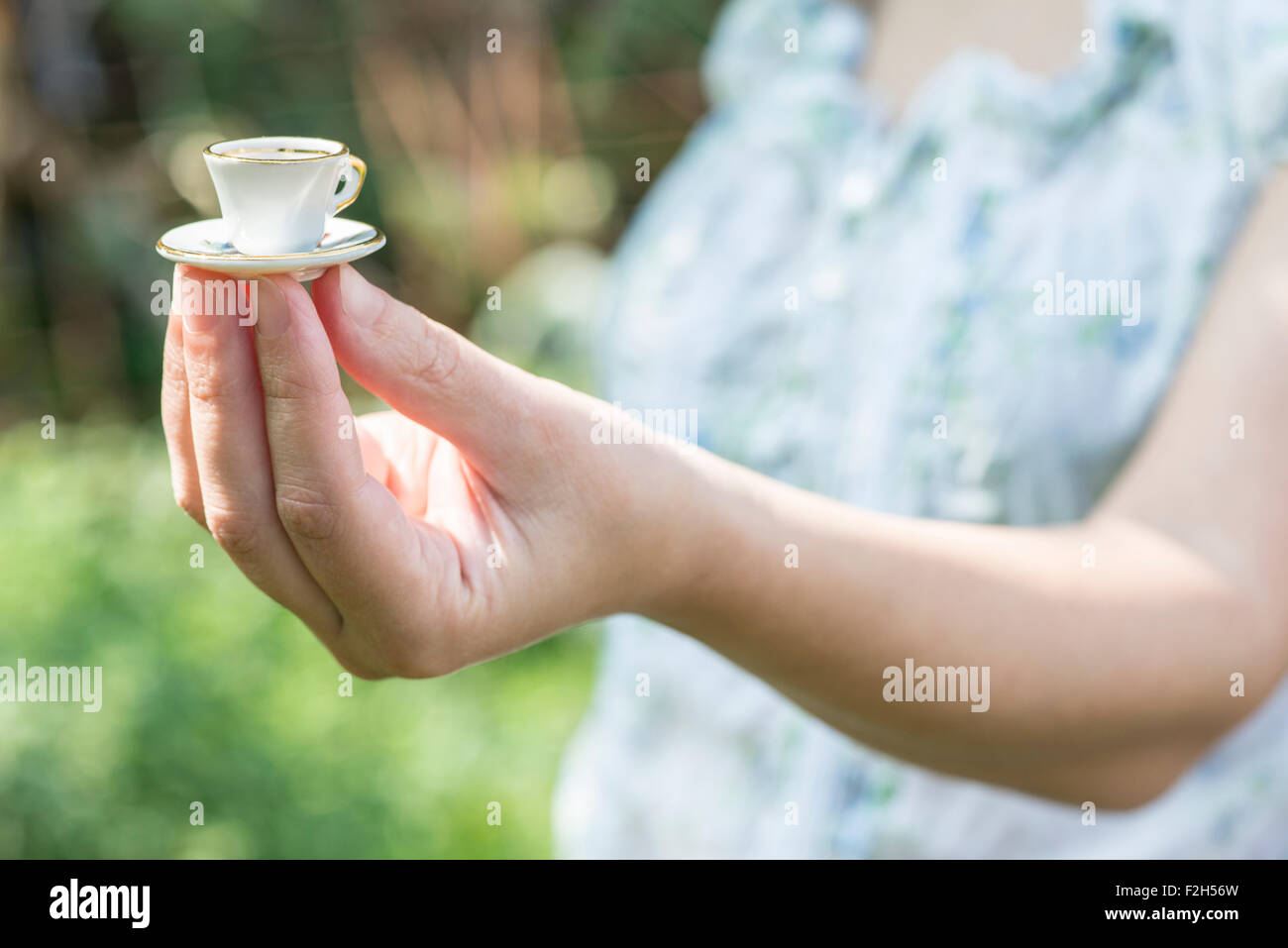 Hand hold very small cup of coffee. Miniature cup Stock Photo - Alamy