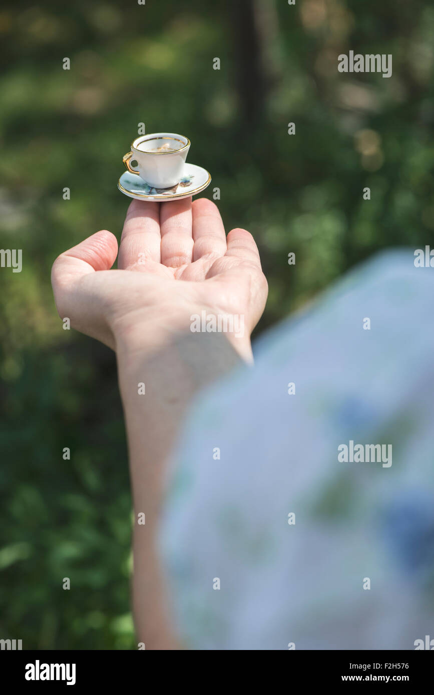 Hand hold very small cup of coffee. Miniature cup Stock Photo - Alamy
