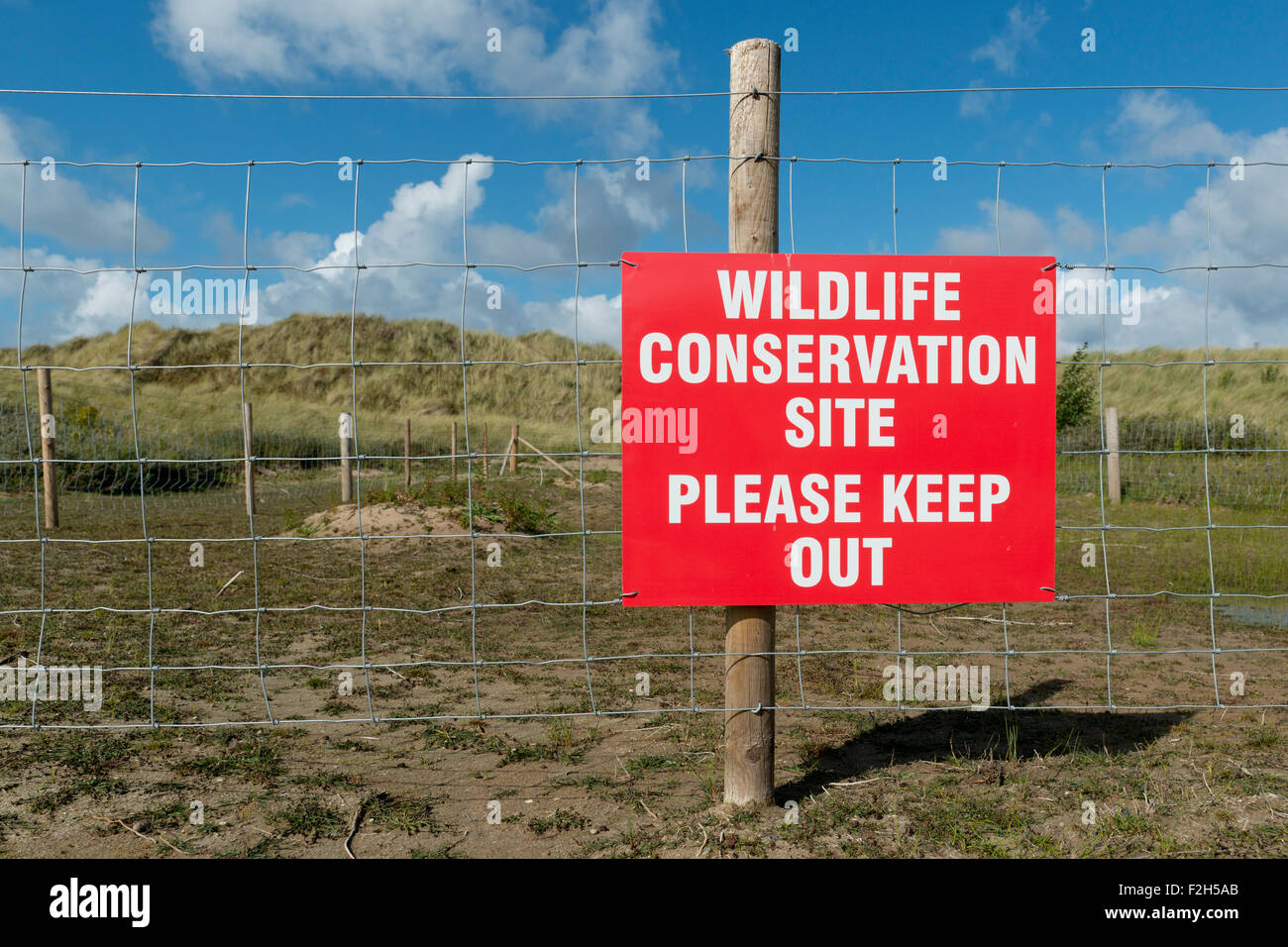 Signage on a fence around a wildlife conservation site at Gronant dunes ...