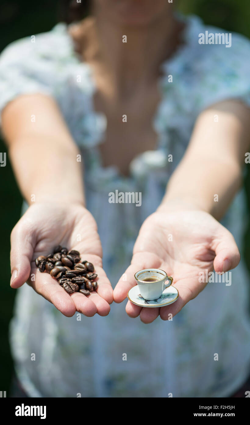 Hand hold very small cup of coffee. Miniature cup Stock Photo - Alamy