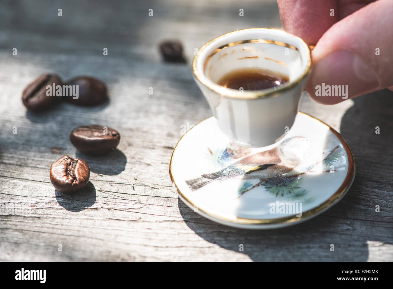Cup of coffee on wooden table. Small miniature cup Stock Photo - Alamy