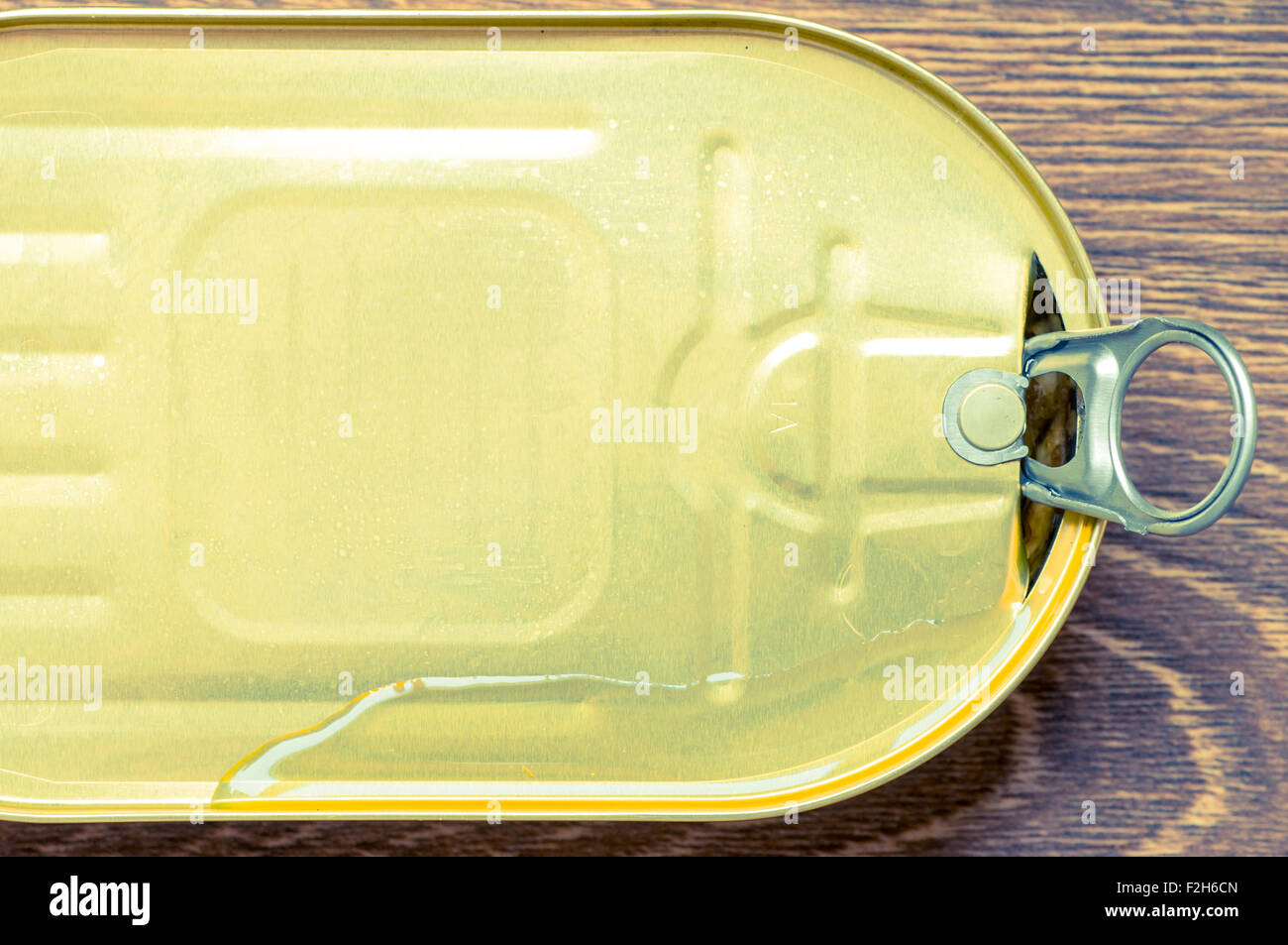 Oil flows through the lid of a tin can top view Stock Photo - Alamy