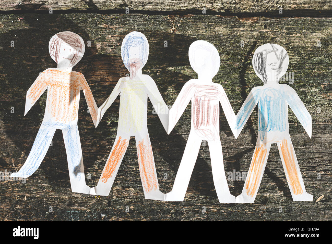 Paper made people figures. Painted white figures on wooden board Stock ...