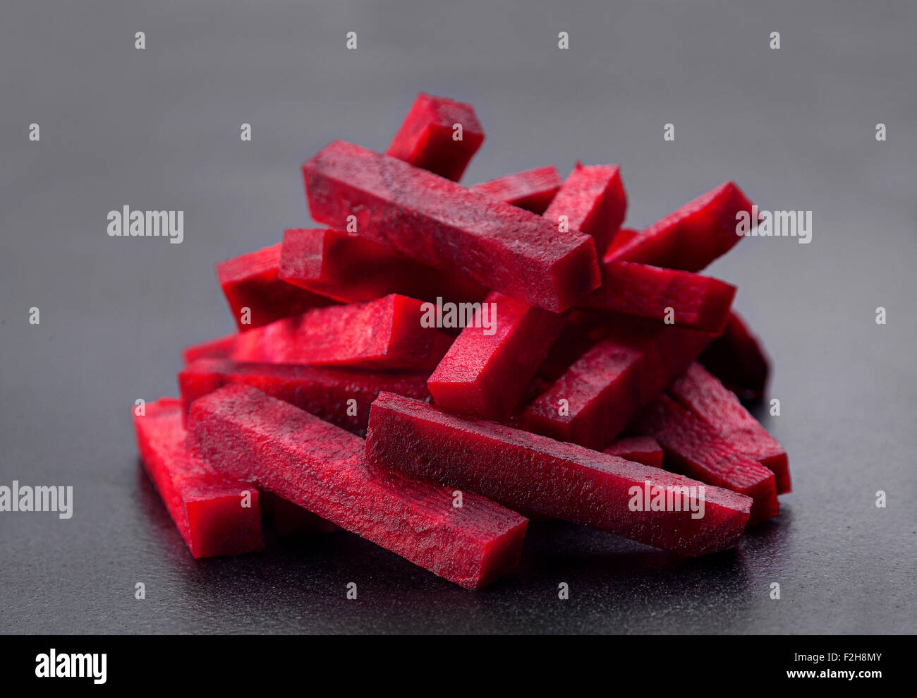 Beetroot slice striped closeup on dark background Stock Photo - Alamy