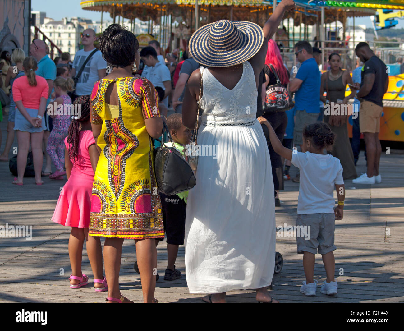 Colorful clothes being worn by visitors to Brighton Pier Stock Photo ...