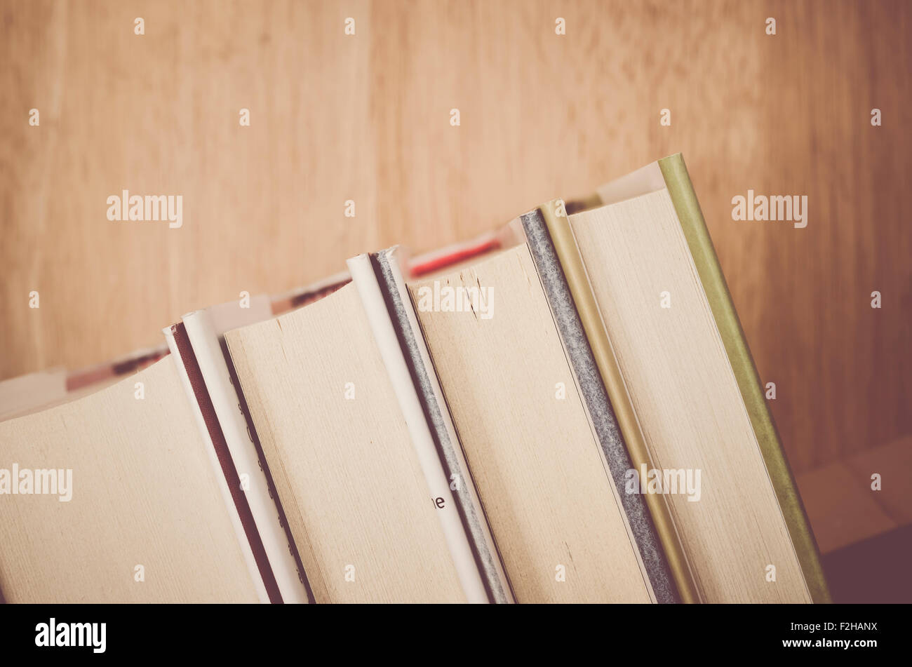 books and manuals lined up on a wooden background - reading and ...