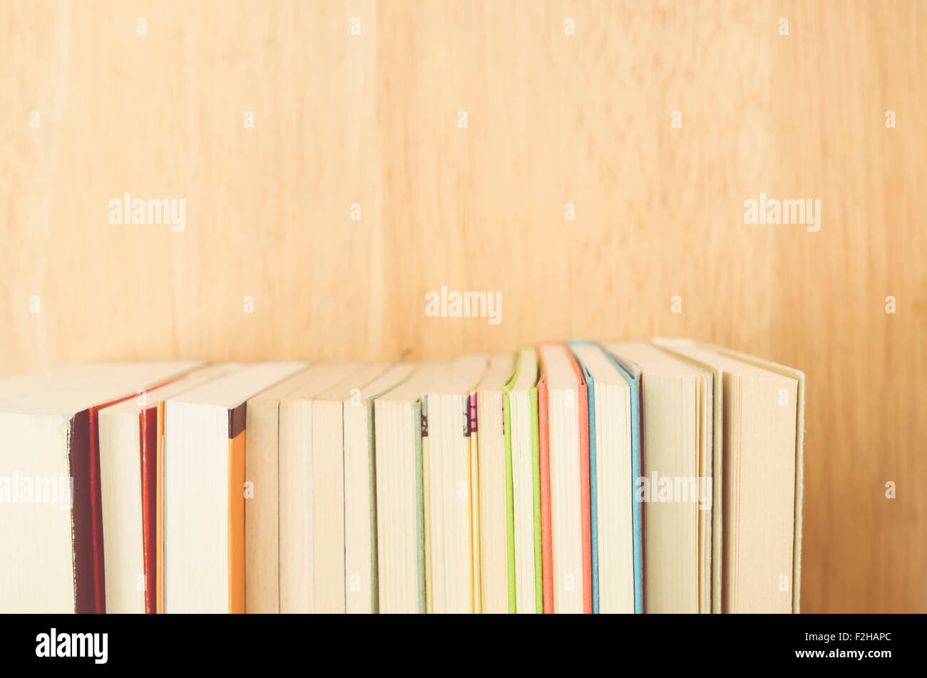 books and manuals lined up side view - natural wood background Stock ...