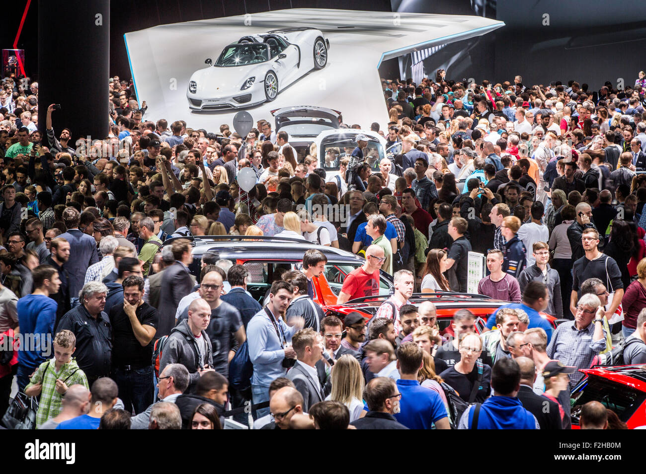 Visitors flock to the exhibition stands of Skoda (bottom) and Porsche ...