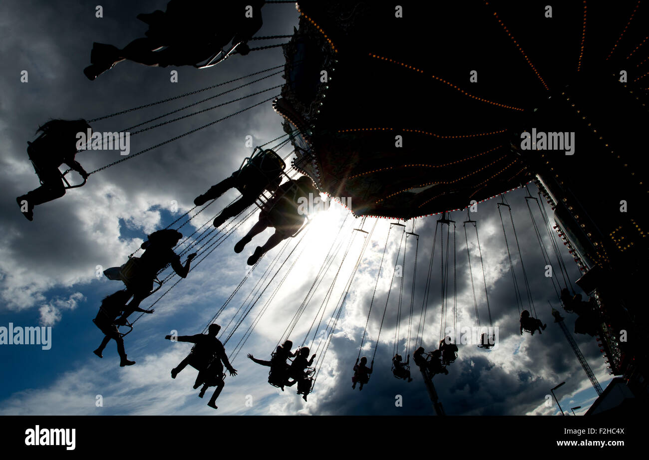 Munich, Germany. 19th Sep, 2015. Visitor take a ride on a swing ...
