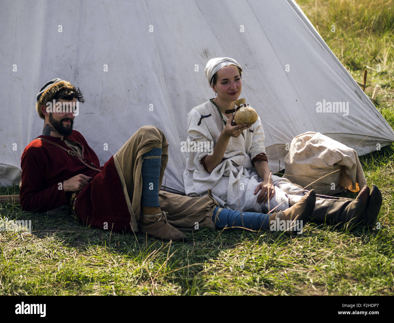 Sept. 19, 2015 - Enactors in medieval clothes resting near the tent ...
