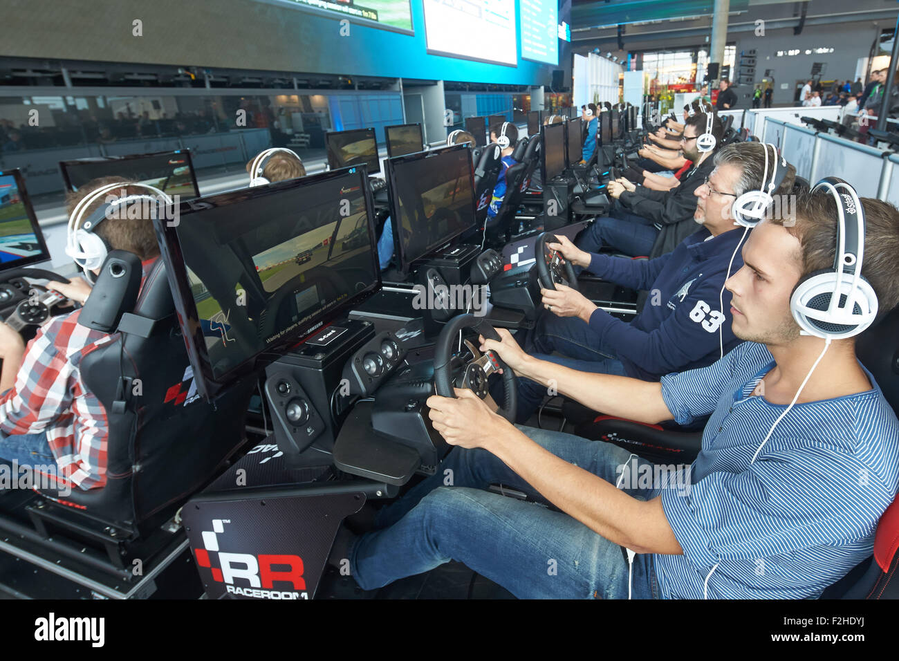 Participants of the ADAC Sim Racing Trophy in front of the simulator ...