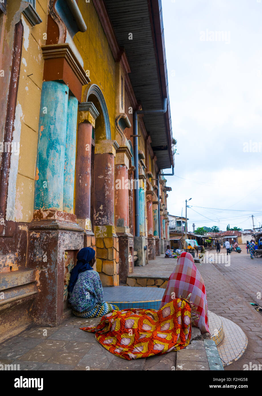Benin, West Africa, Porto-Novo, teenagers sit in front of the ...