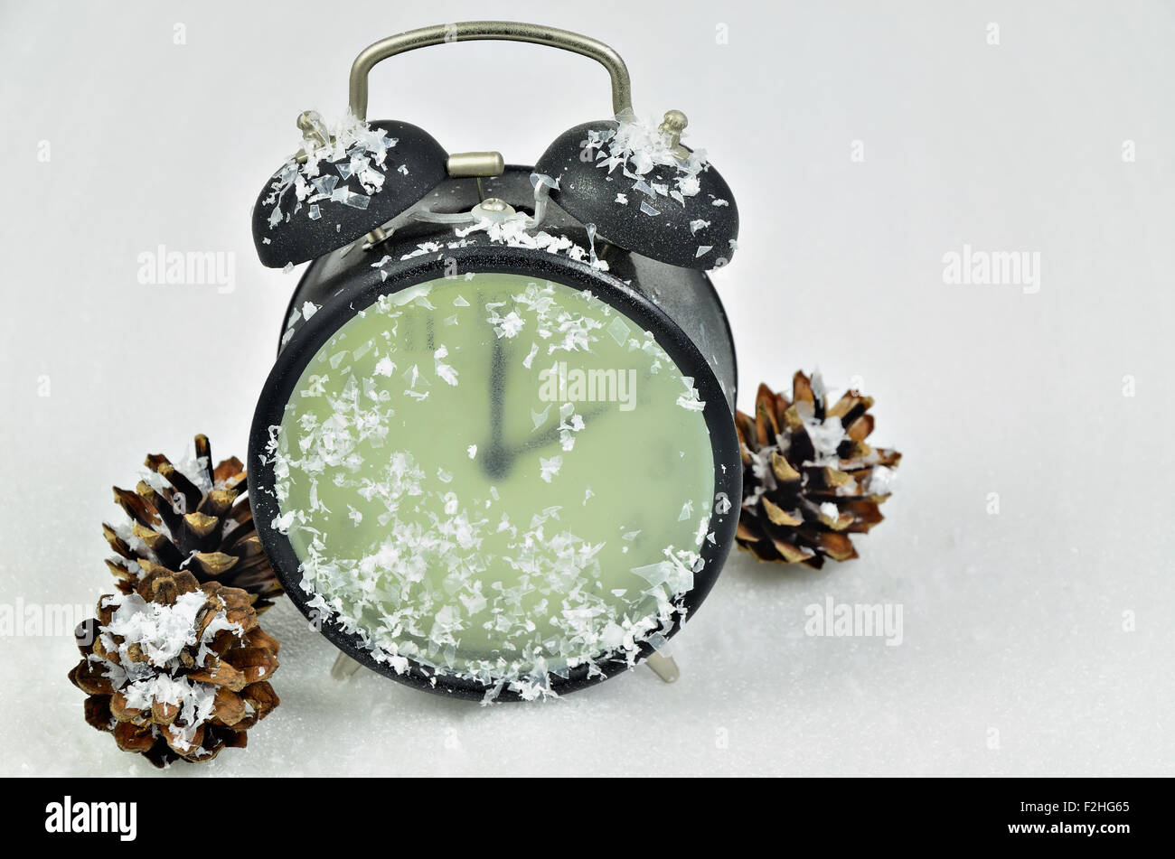 close up of a snowy black retro alarm clock, showing winter time, 2 am ...