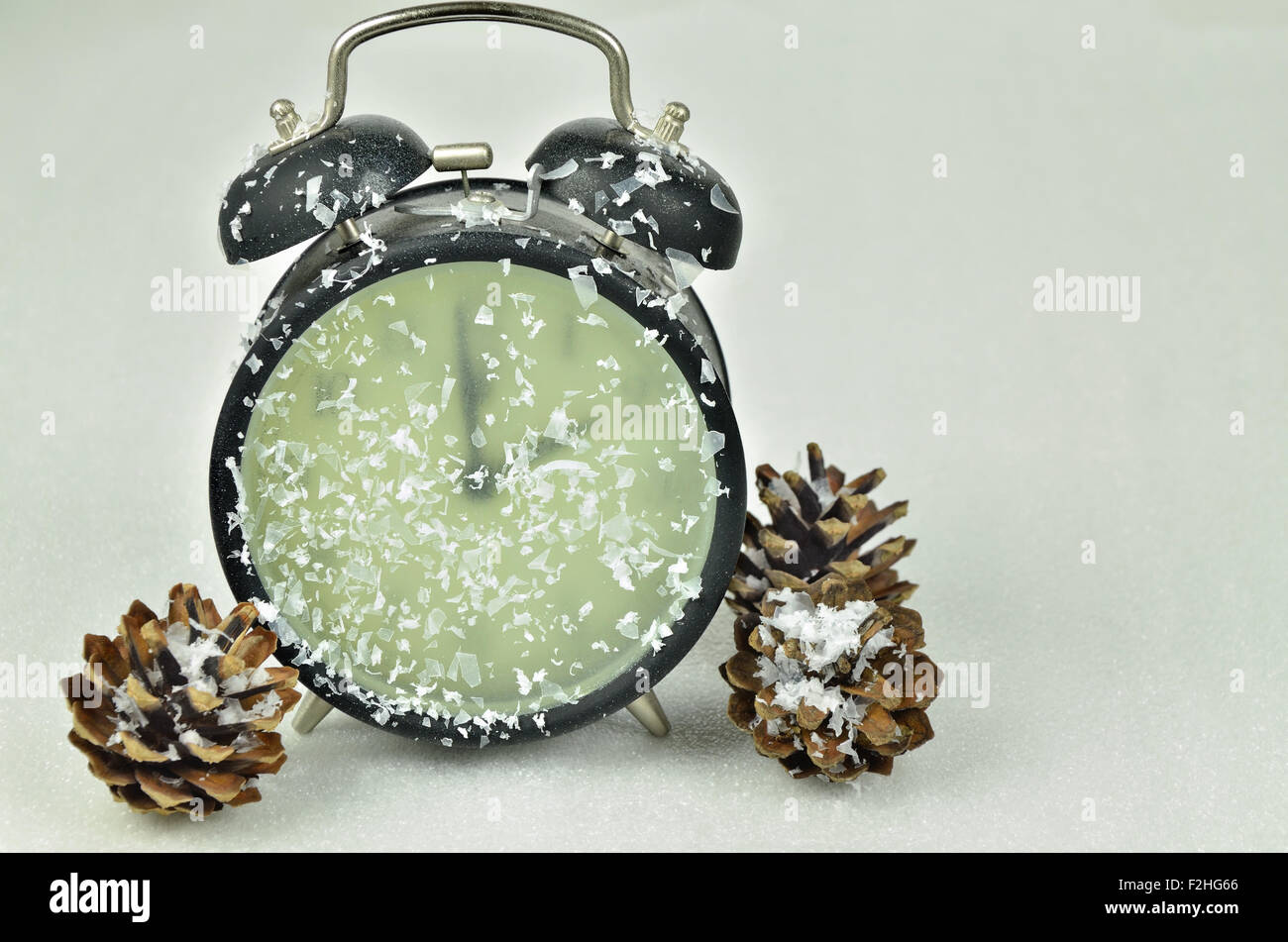 close up of a snowy black retro alarm clock, showing winter time, 2 am ...