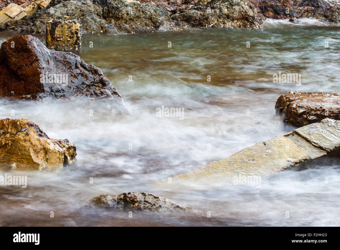 Waves hit the rocks Stock Photo - Alamy