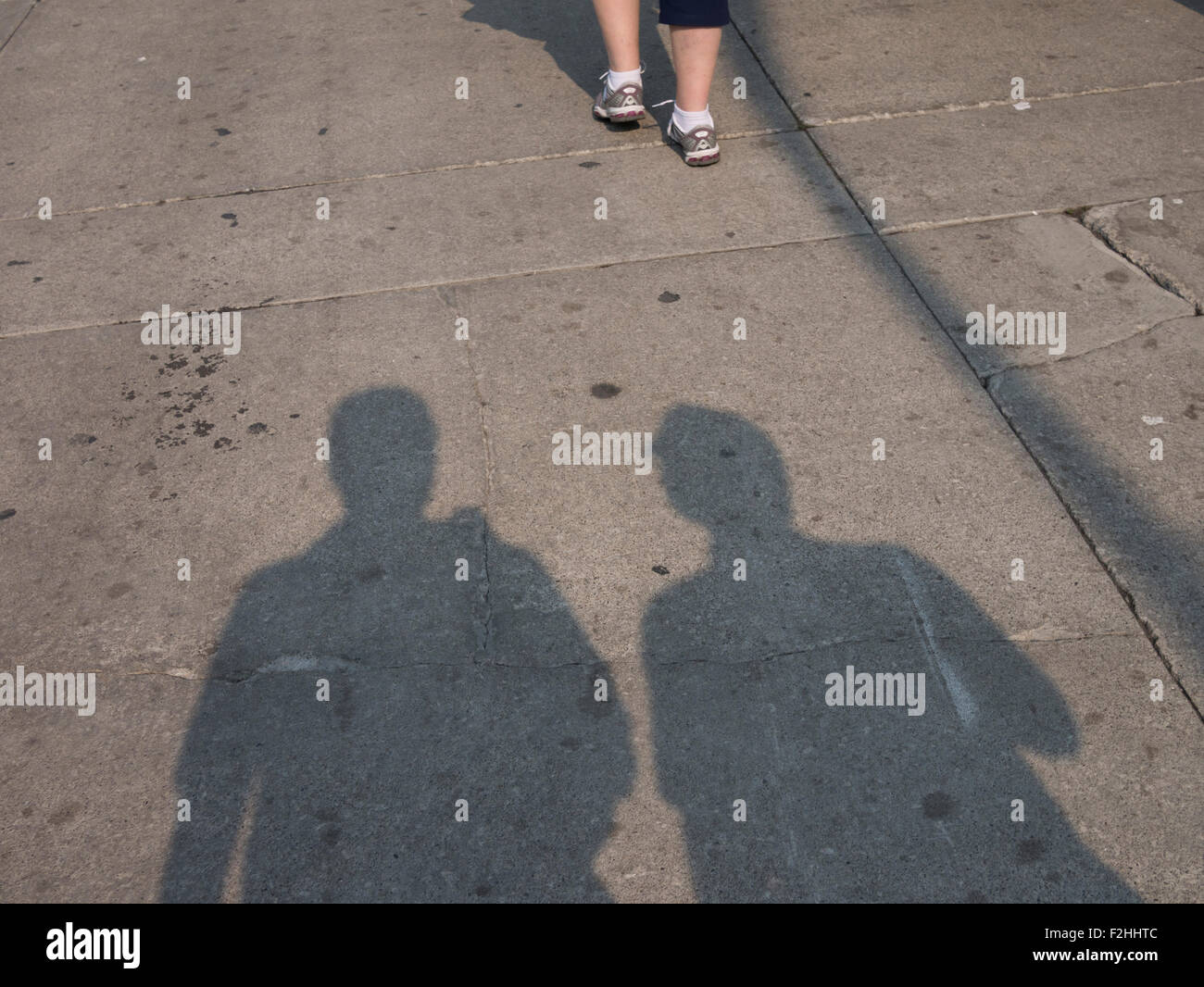Shadow of people in sidewalk Stock Photo - Alamy