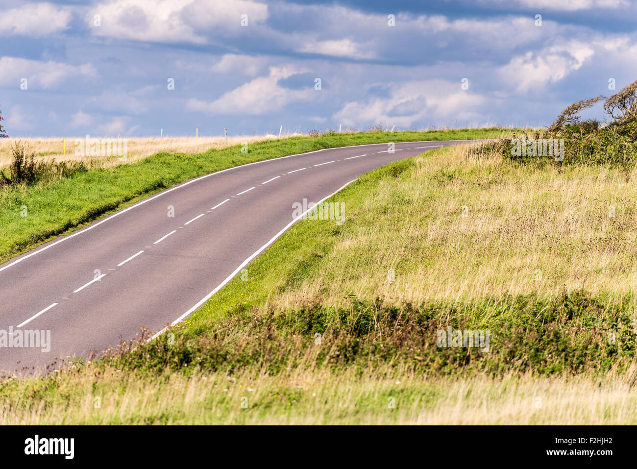 Empty country road across a hillside Stock Photo - Alamy