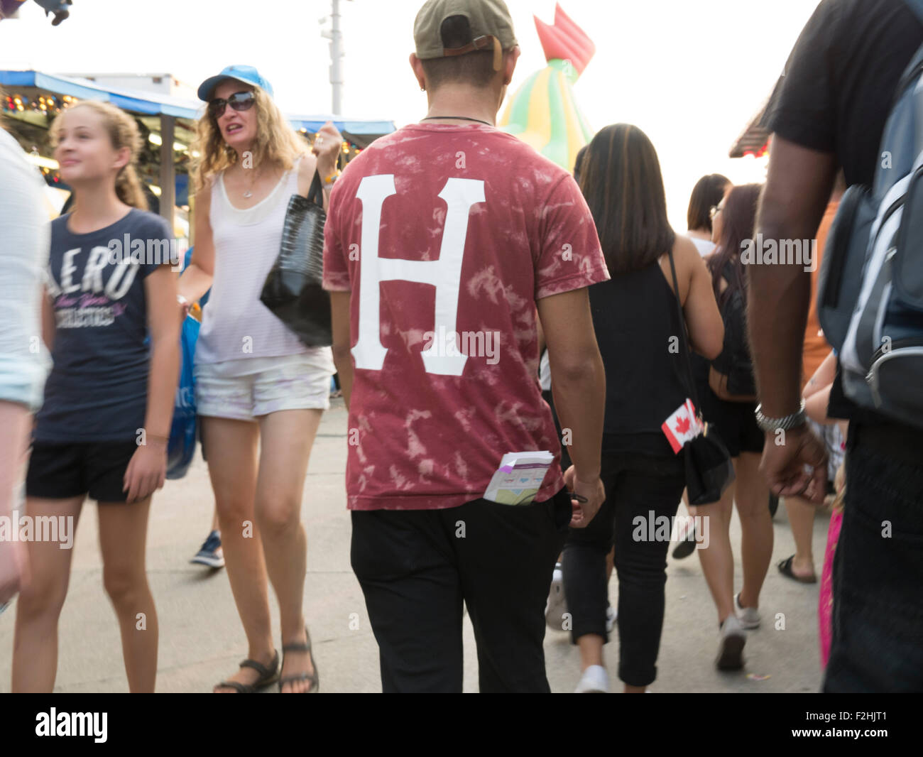 Tourists and visitors walking along a street fair Stock Photo - Alamy