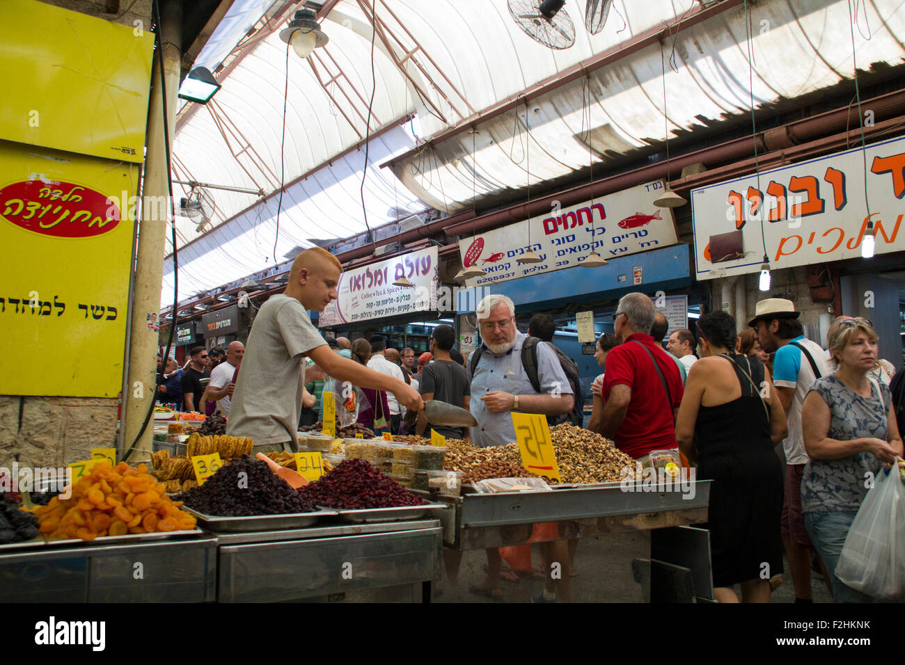 Jerusalem,Israel - JULY 30, 2013:A stall holder serves customers at the ...
