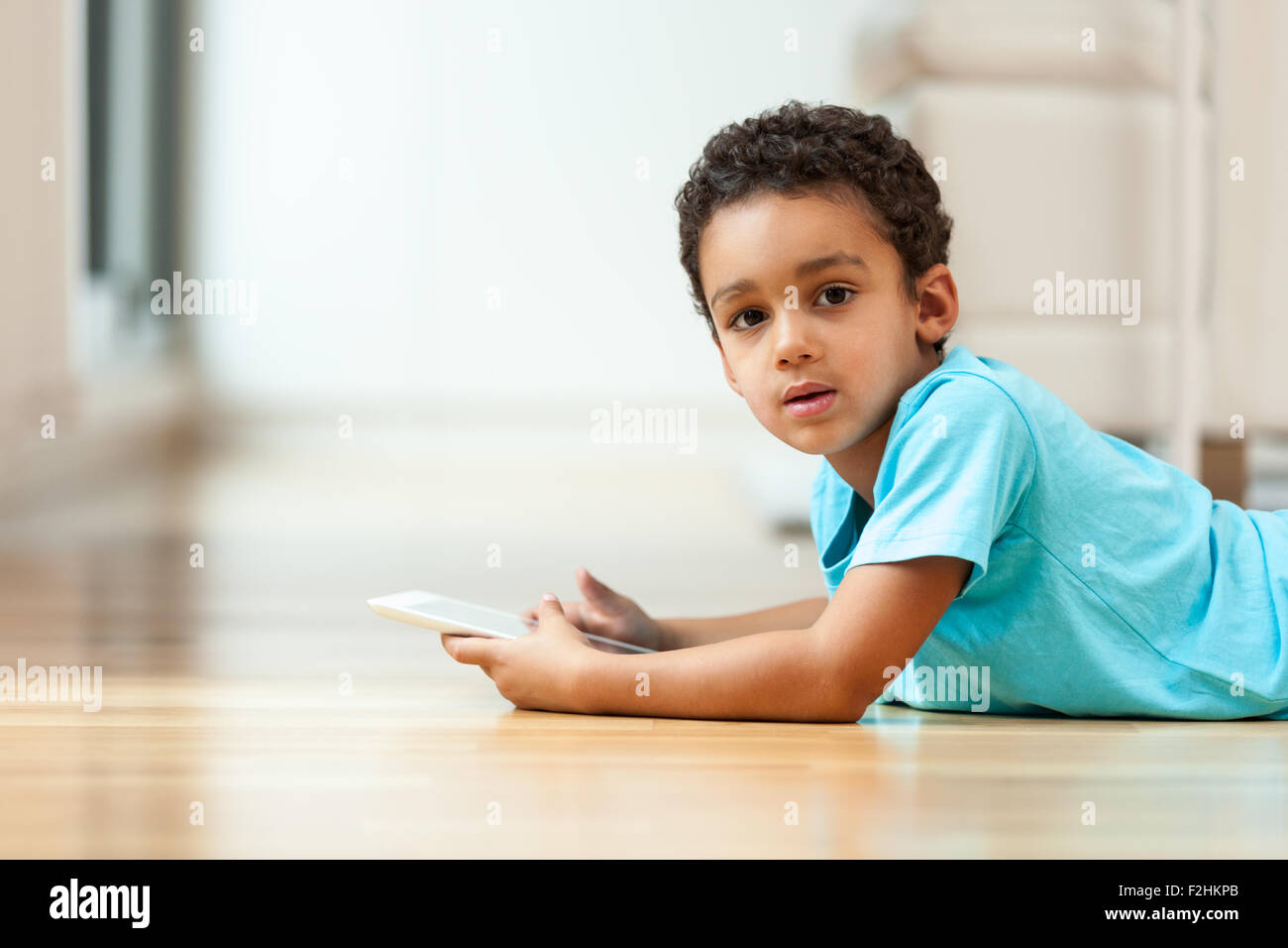 African american little boy using a tactile tablet Stock Photo - Alamy