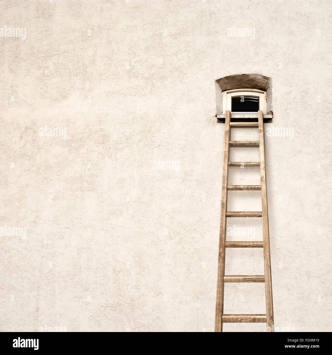 wall with a small window and wooden ladder Stock Photo - Alamy
