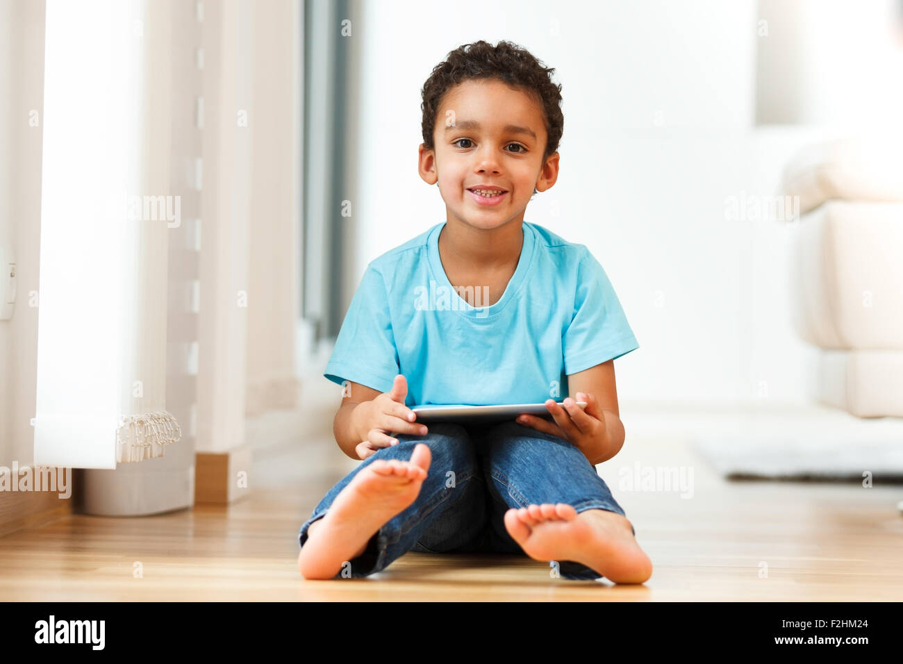 African american little boy using a tactile tablet Stock Photo - Alamy
