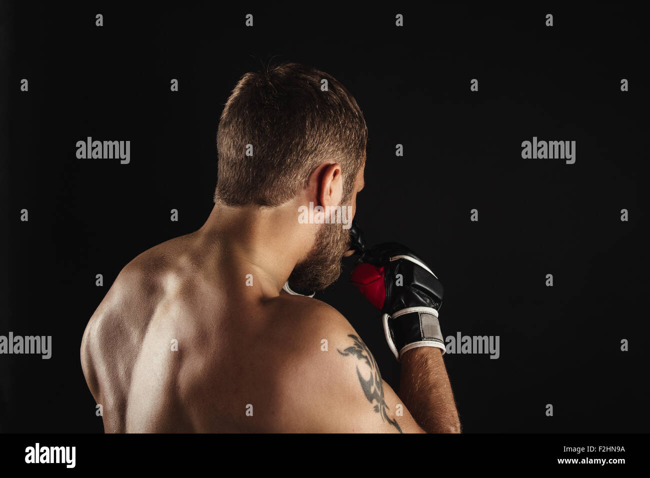 Athletic bearded boxer with gloves on a dark background Stock Photo - Alamy