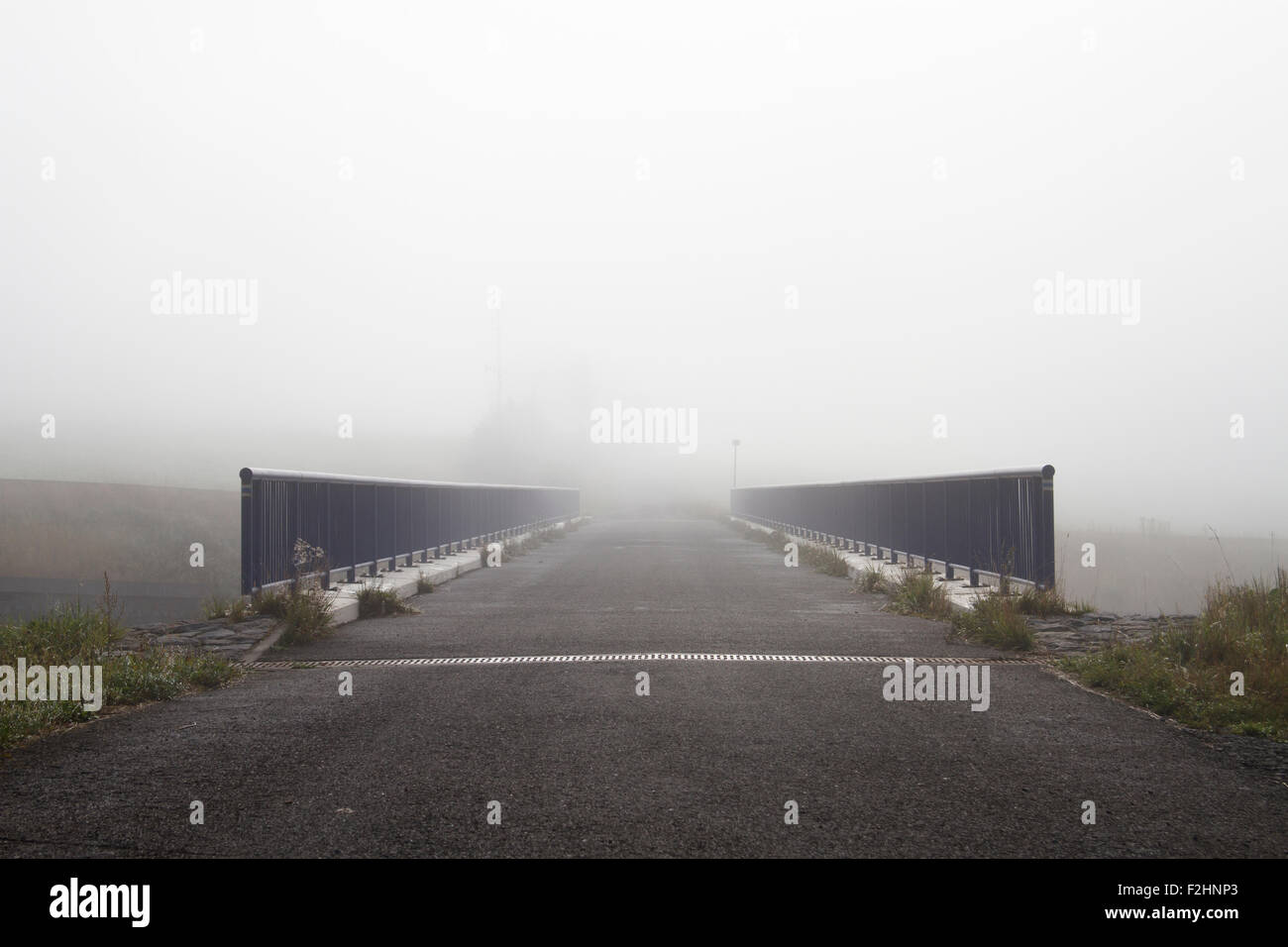 Bridge rails disappearing into fog Stock Photo - Alamy
