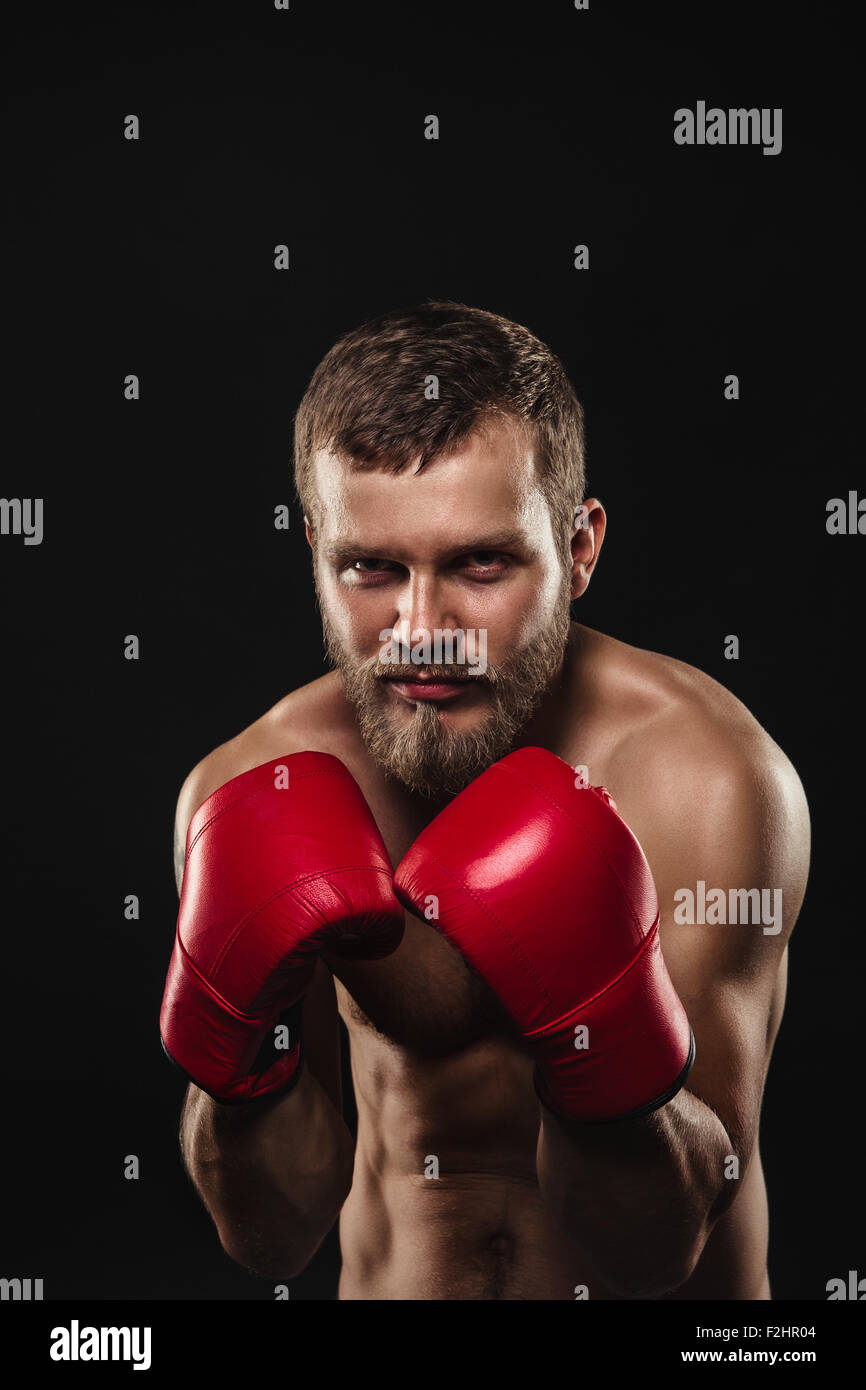 Athletic bearded boxer with gloves on a dark background Stock Photo - Alamy