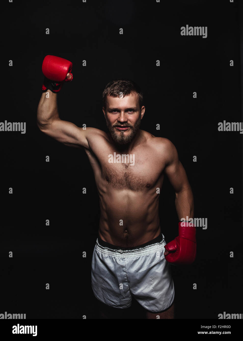 Athletic bearded boxer with gloves on a dark background Stock Photo - Alamy