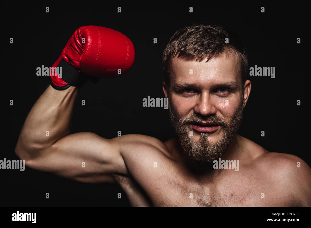Athletic bearded boxer with gloves on a dark background Stock Photo - Alamy