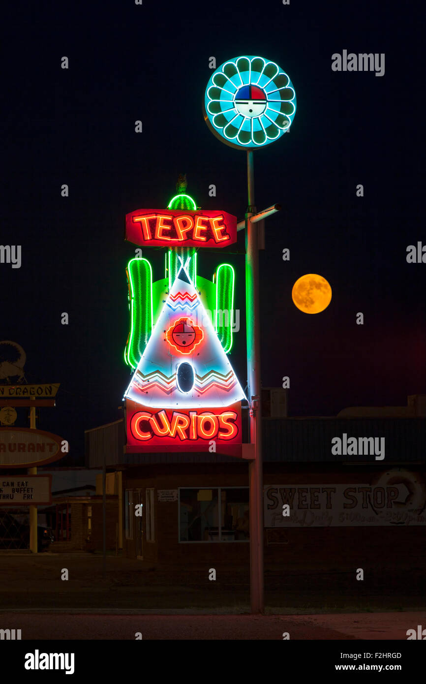 A full moon rises alongside the Tepee Curios neon sign along Route 66 ...