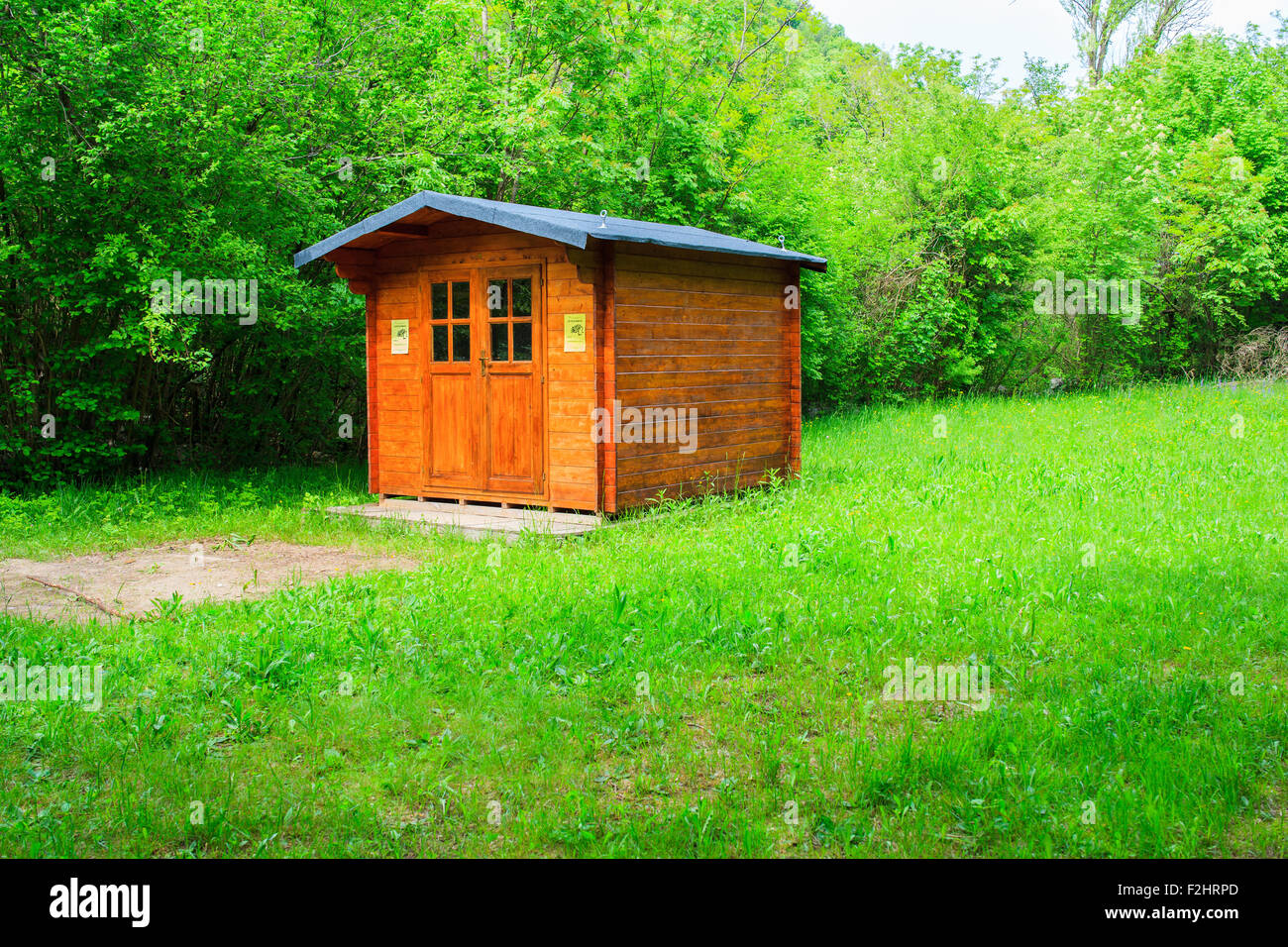 View of little wooden house in the countryside Stock Photo - Alamy