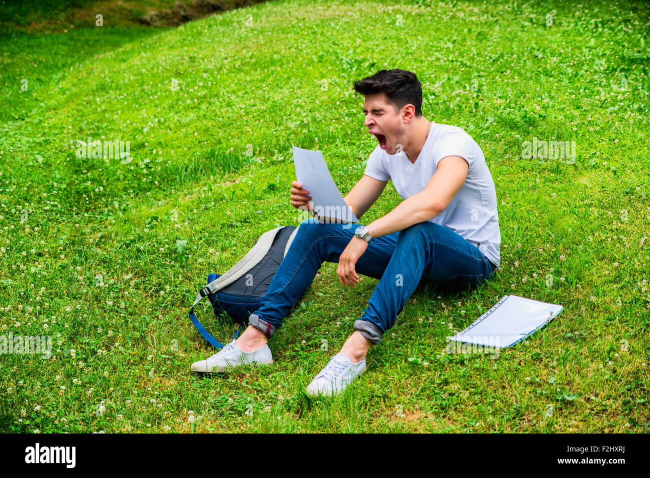 Young Bored, Tired Male Student Studying his Lessons while Yawning ...