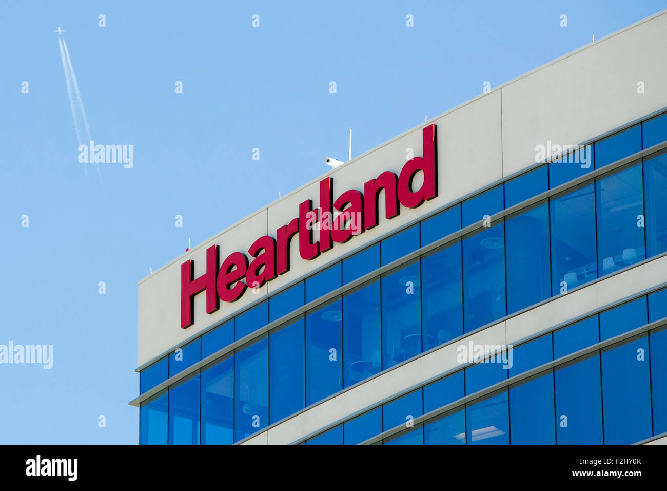 A logo sign outside of a facility occupied by Heartland Payment Systems ...