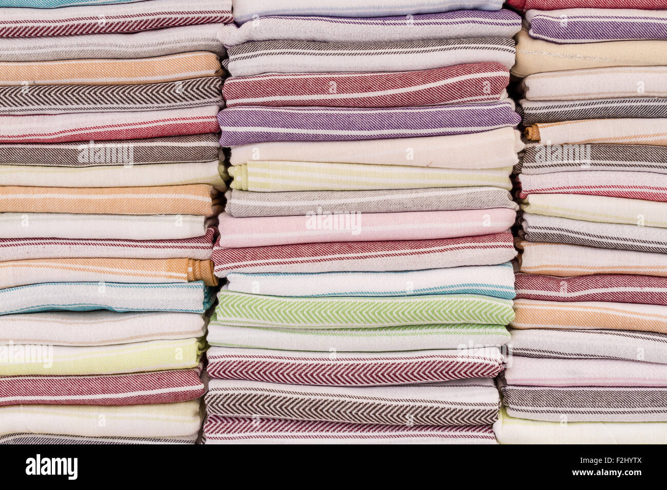 Pile of folded traditional colorful clothes at the market in Bodrum ...